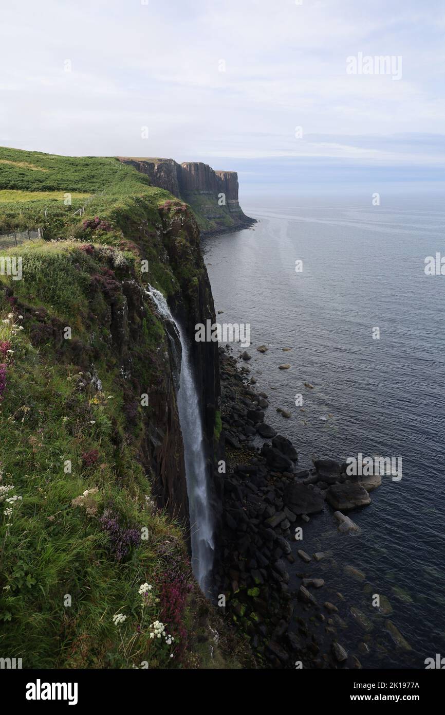 A waterfall on the cliff falling on the sea water Stock Photo - Alamy