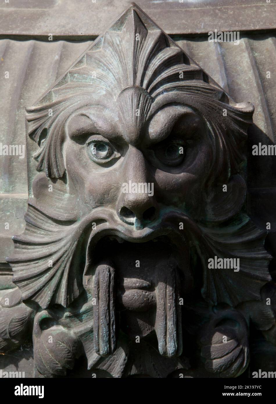 Demonic statue face made of metal on a street lamp Stock Photo - Alamy