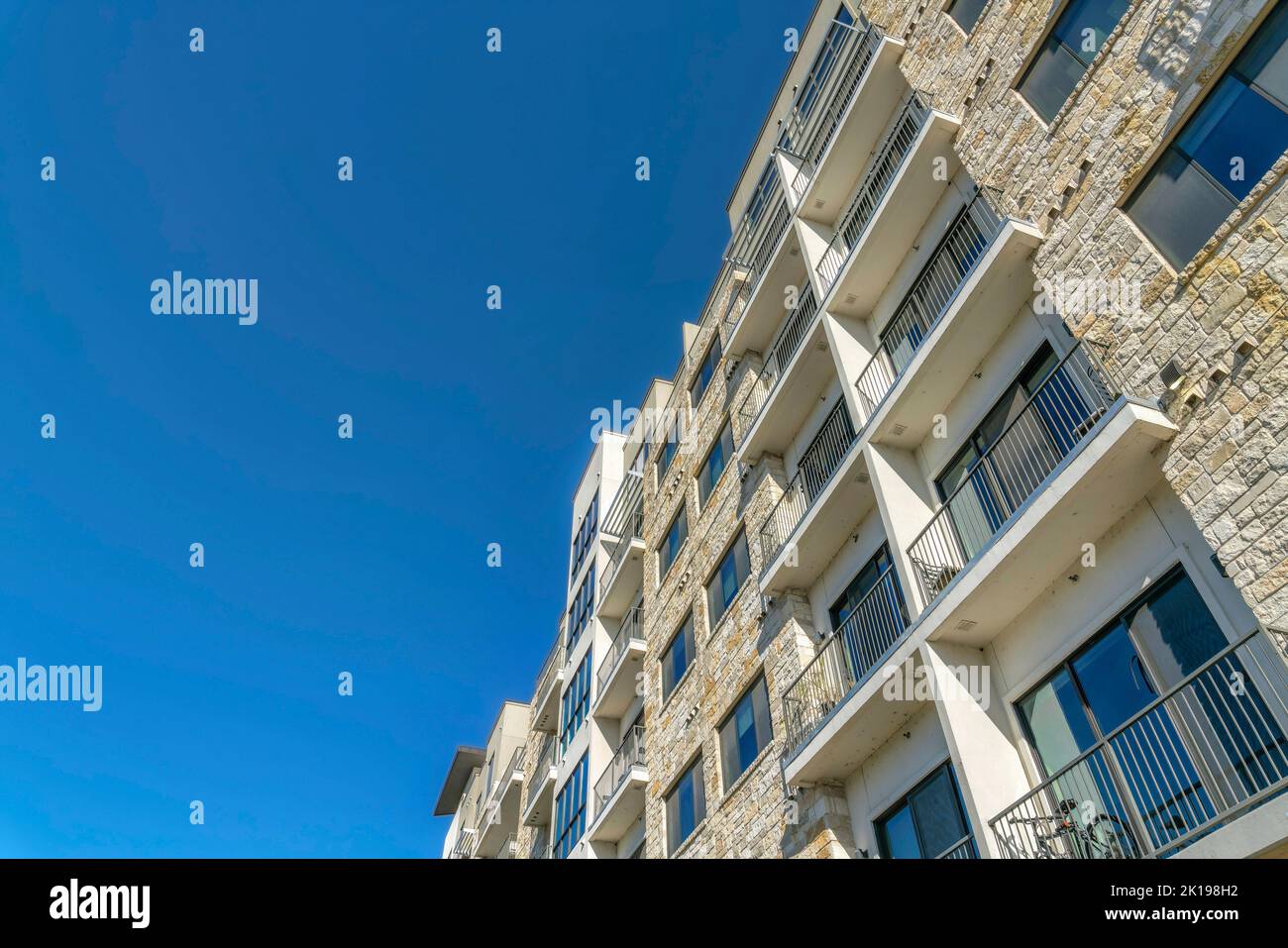 Expensive luxury apartments with small balconies and stone brick wall ...