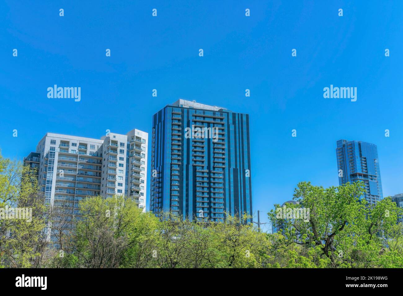 Facade of apartment complex with vibrant blue sky background in Austin ...