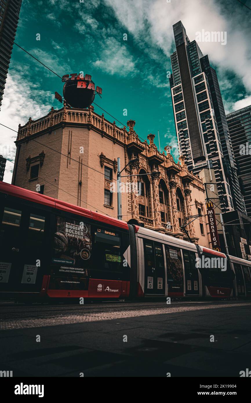 A vertical view of a tram passing through a street with buildings in ...