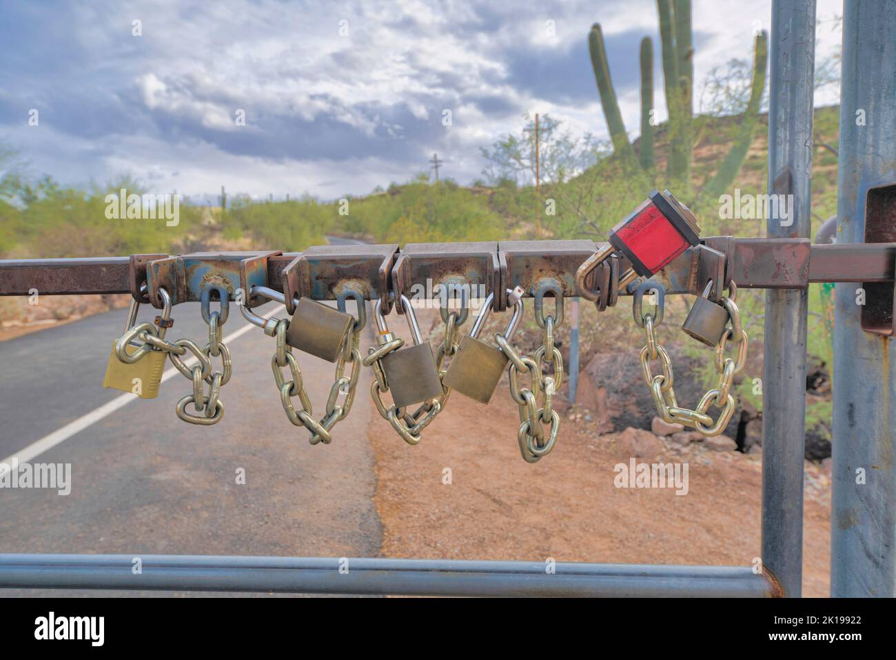 Tucson, Arizona- Multiple padlocks with chains on a gate. Close-up of ...