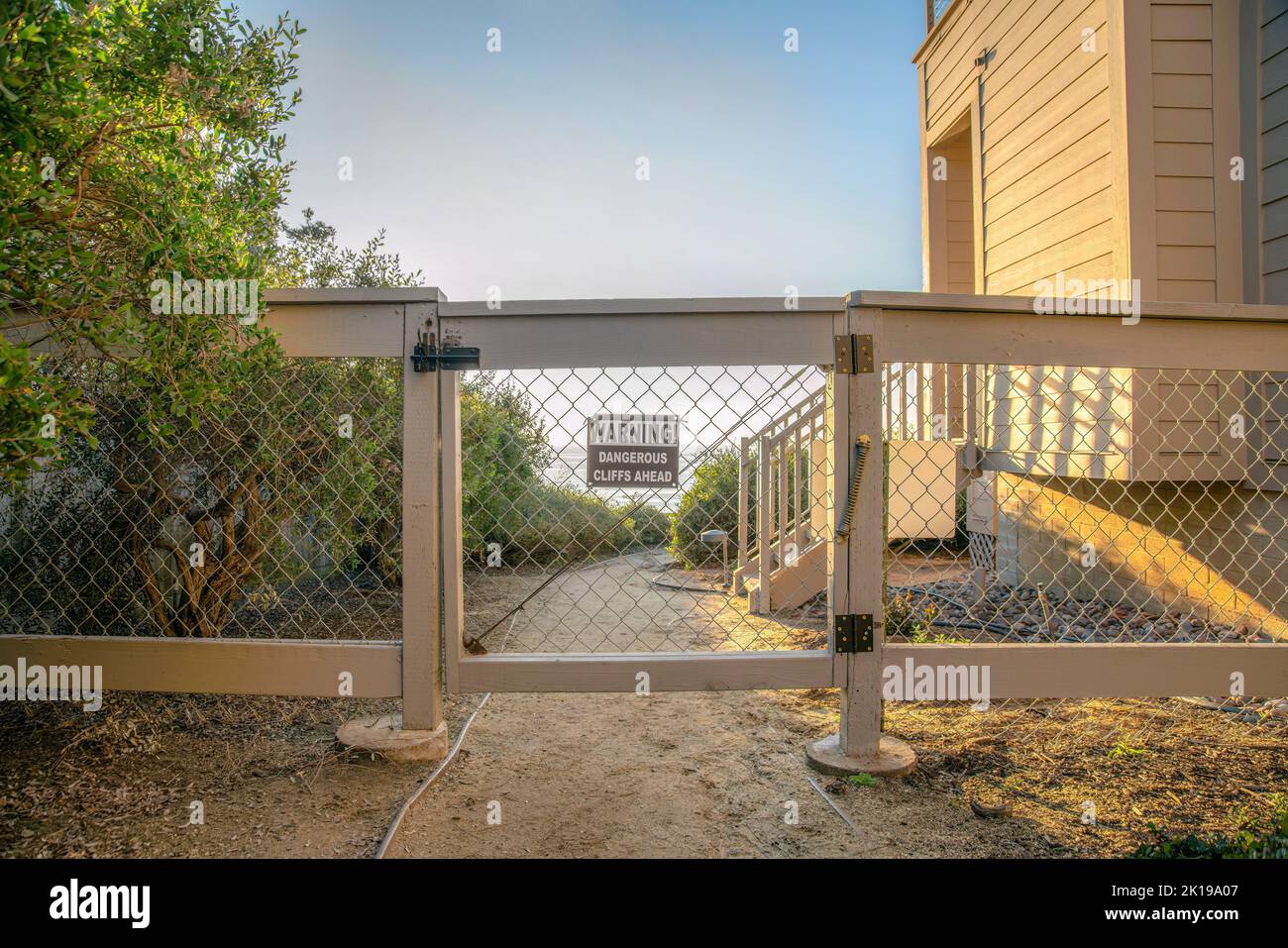 La Jolla, California- Gate and fence with mesh wire and signage with ...