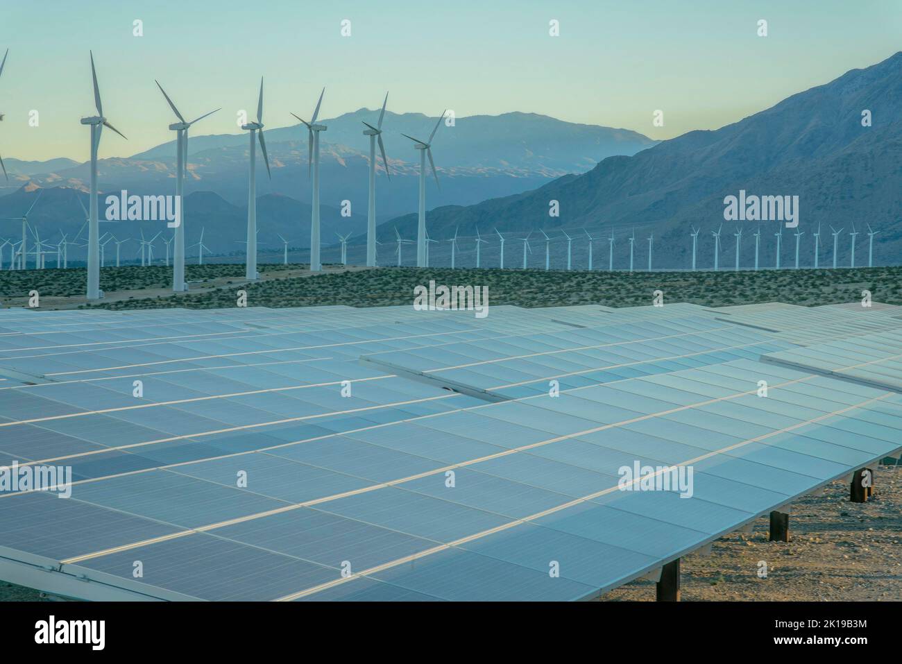 Wind farm with wind turbines and solar panels on a desert at California ...