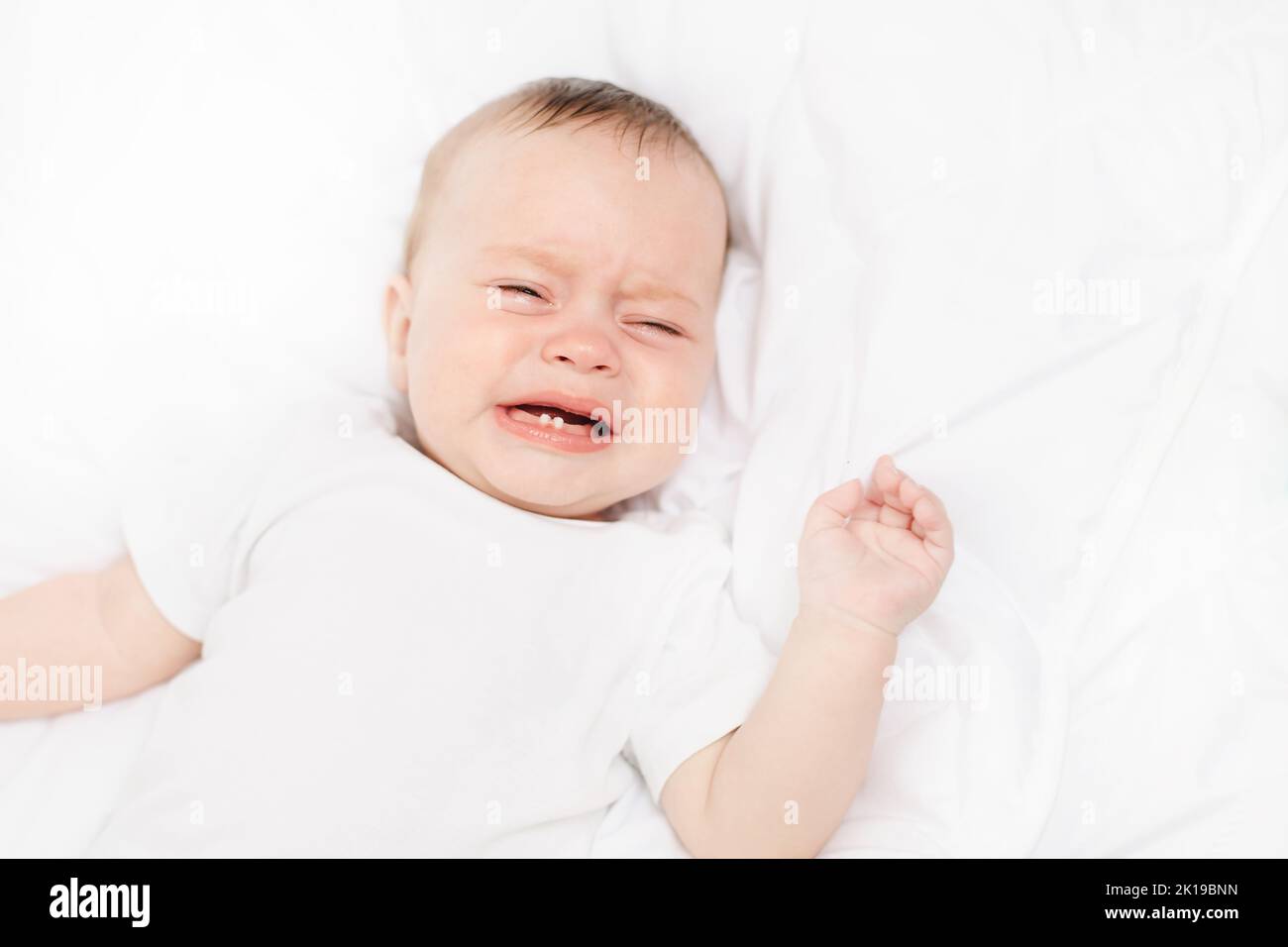 The baby is crying in his crib . The baby 's teeth are teething . Colic ...
