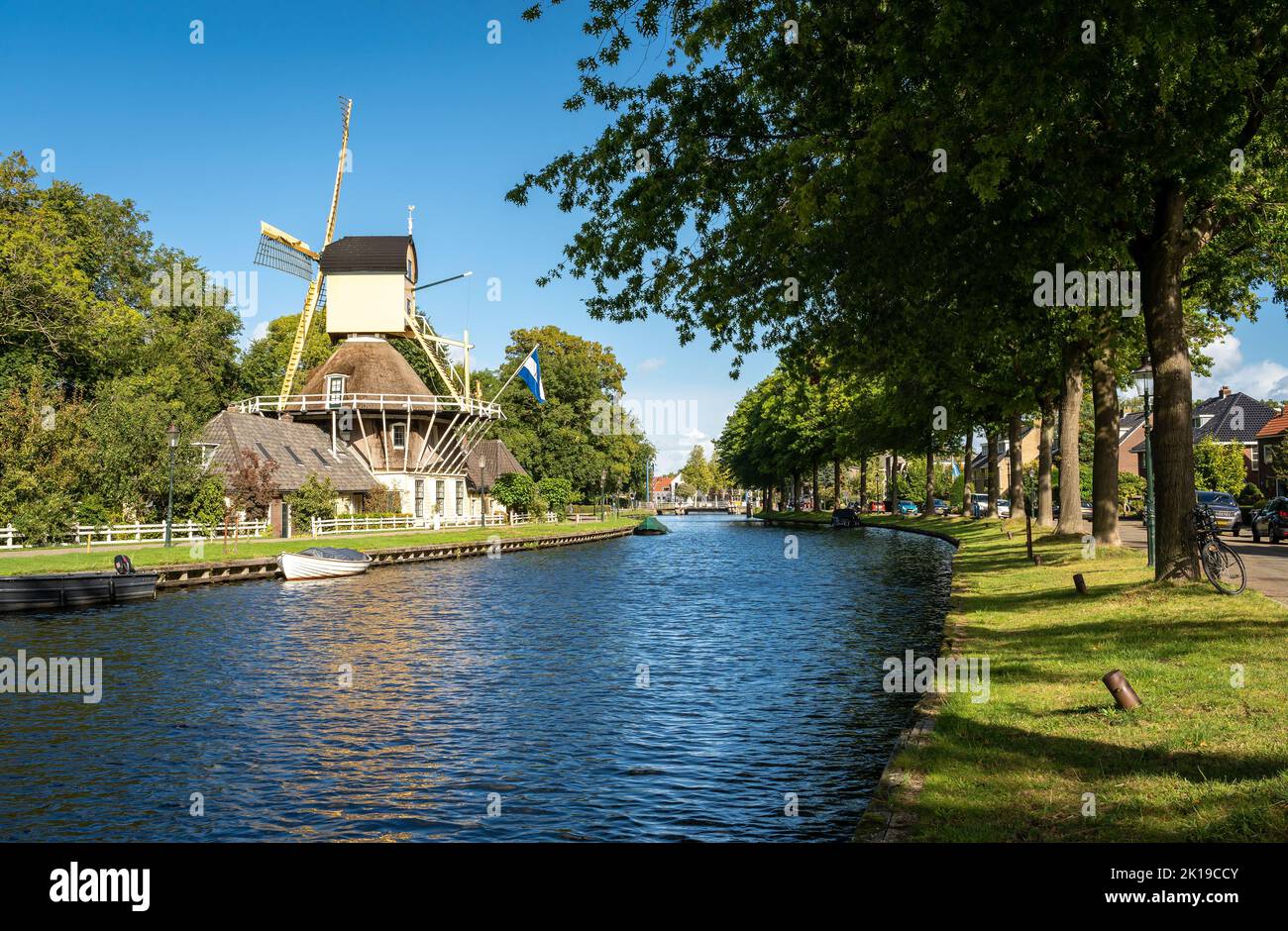 Historical wooden dutch windmill along the canal in the city of Weesp ...