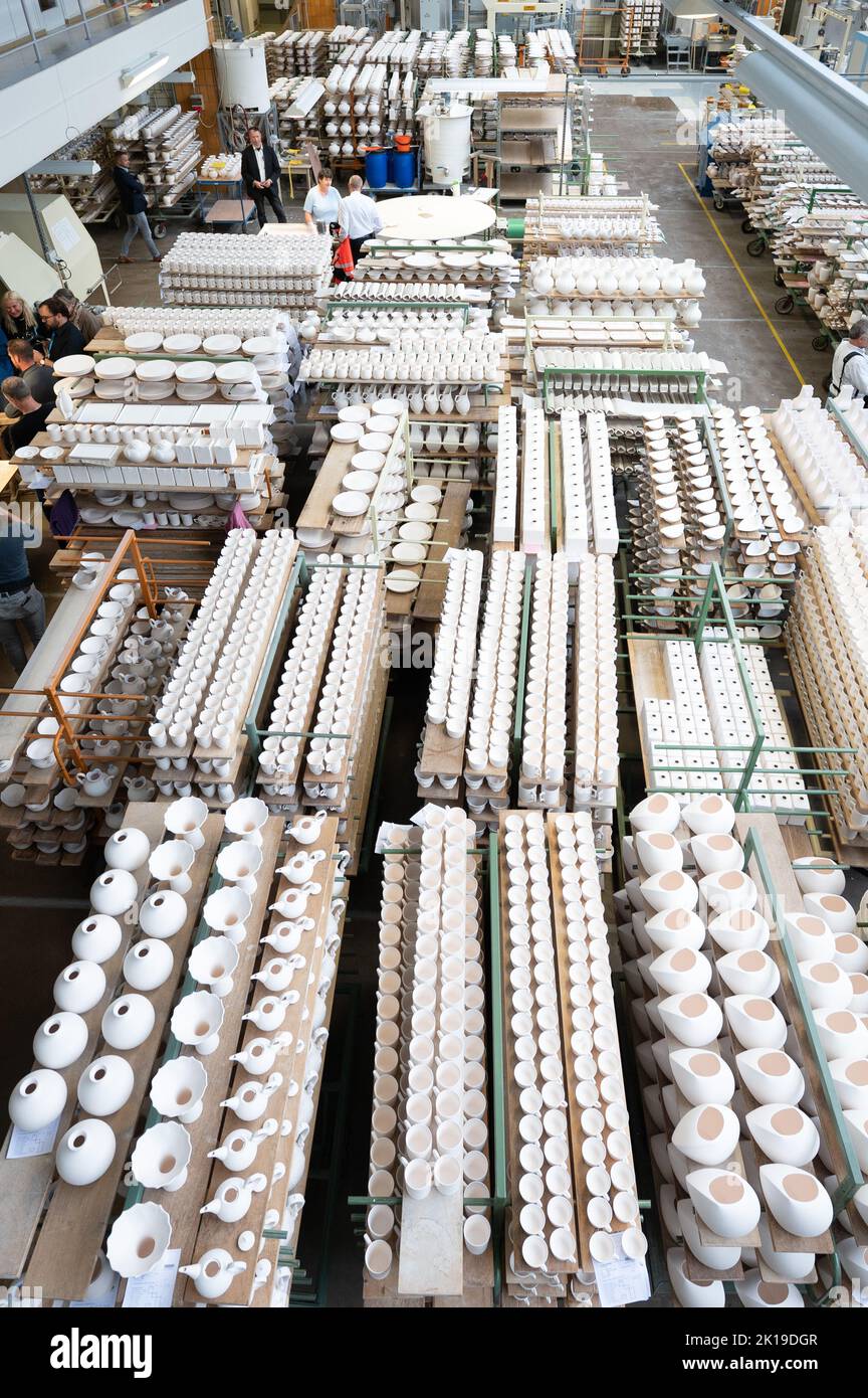 15 September 2022, Saxony, Meißen: Employees stand between the shelves ...