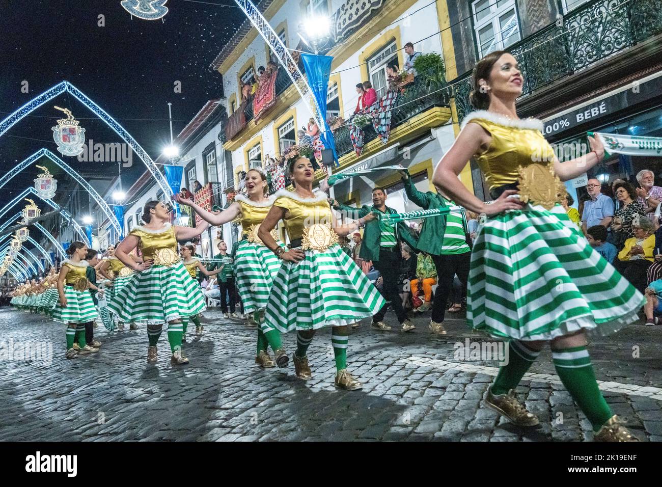 Costumed performers dance down the Rua da Se during a traditional ...