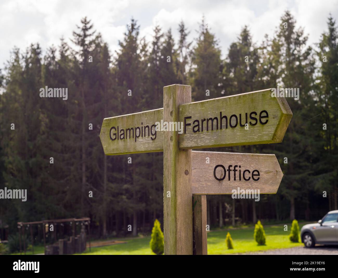 Various sign posts giving directions to holiday accommodation and ...