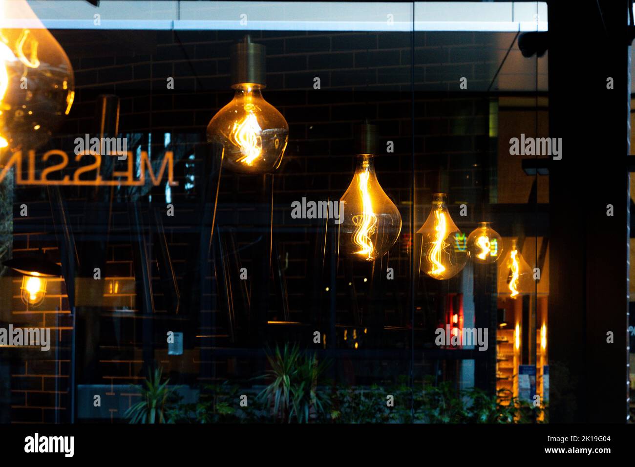 A closeup of hanging lamps in a restaurant taken from outside in Sydney ...