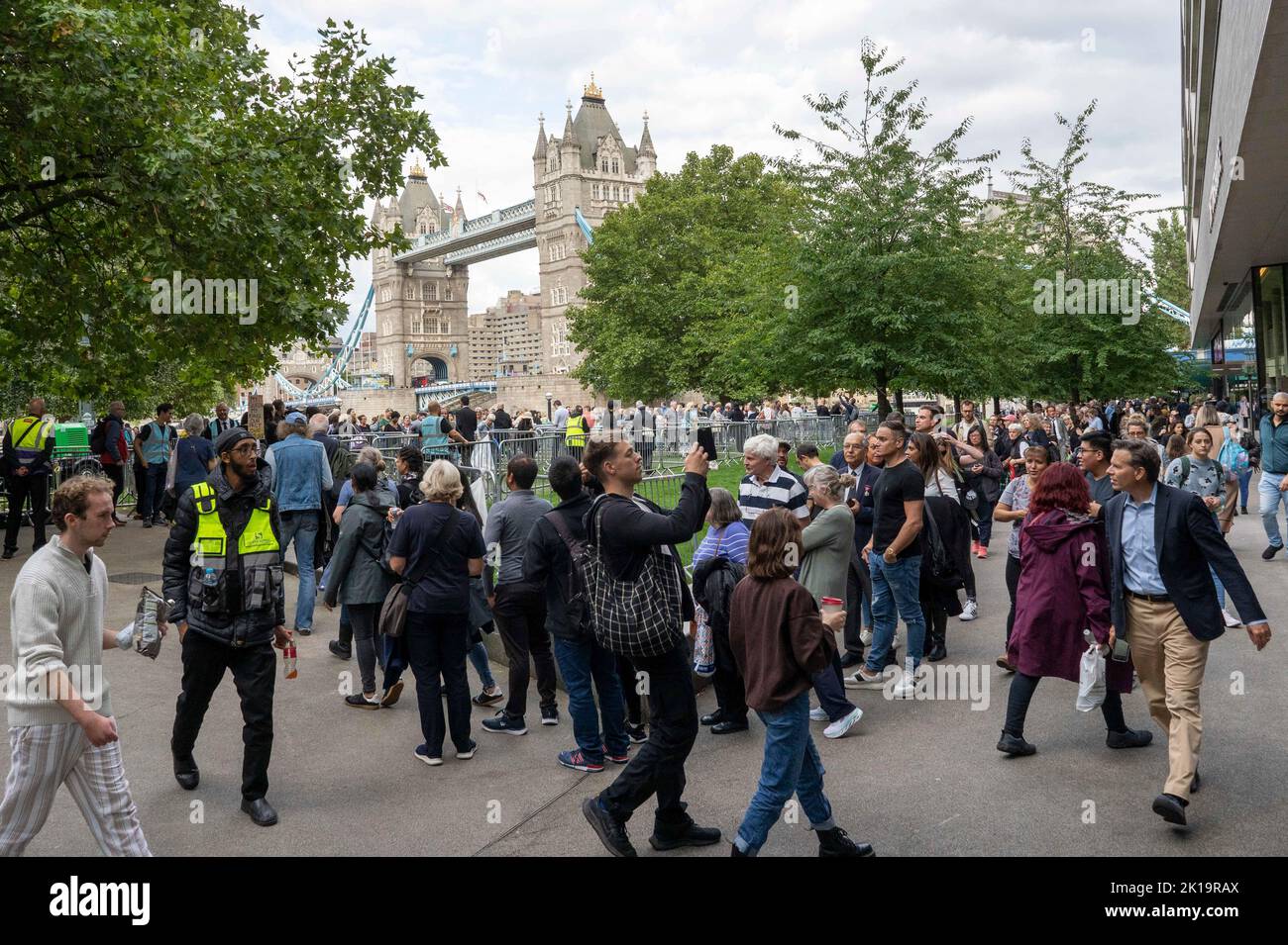 Members of the public queue back to tower bridge to pay their respects ...