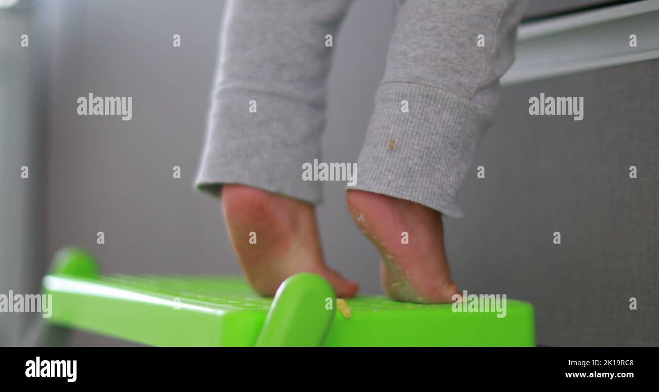 Baby standing on tiptoes reaching out, cute one year old infant on ...