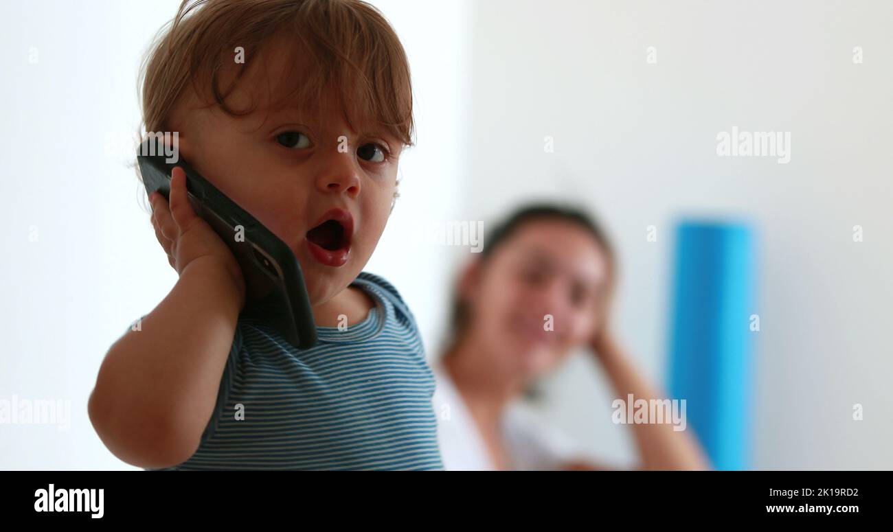 Baby talking on phone, infant with cellphone in ear, toddler giving ...