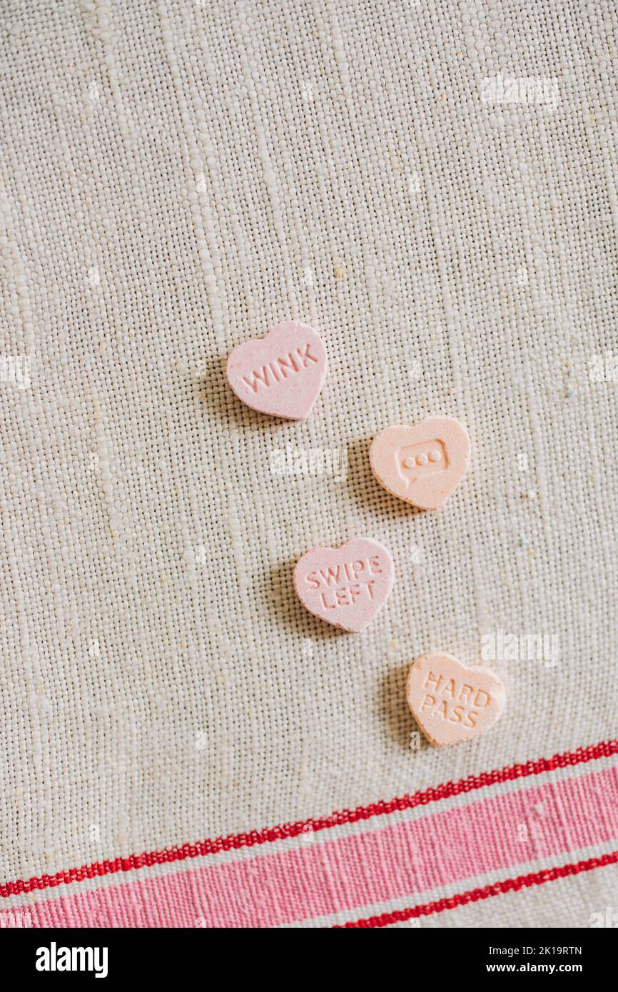 Valentine pastel candy conversation hearts with words on cloth, "swipe ...