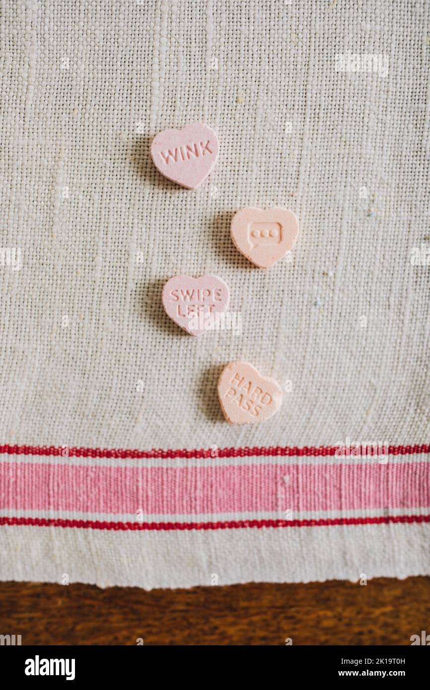 Valentine pastel candy conversation hearts with words on cloth, "swipe ...