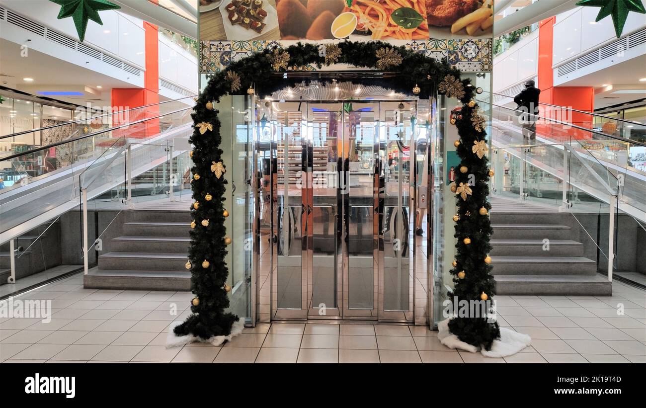 Christmas decorations and storefronts in the background at shopping ...
