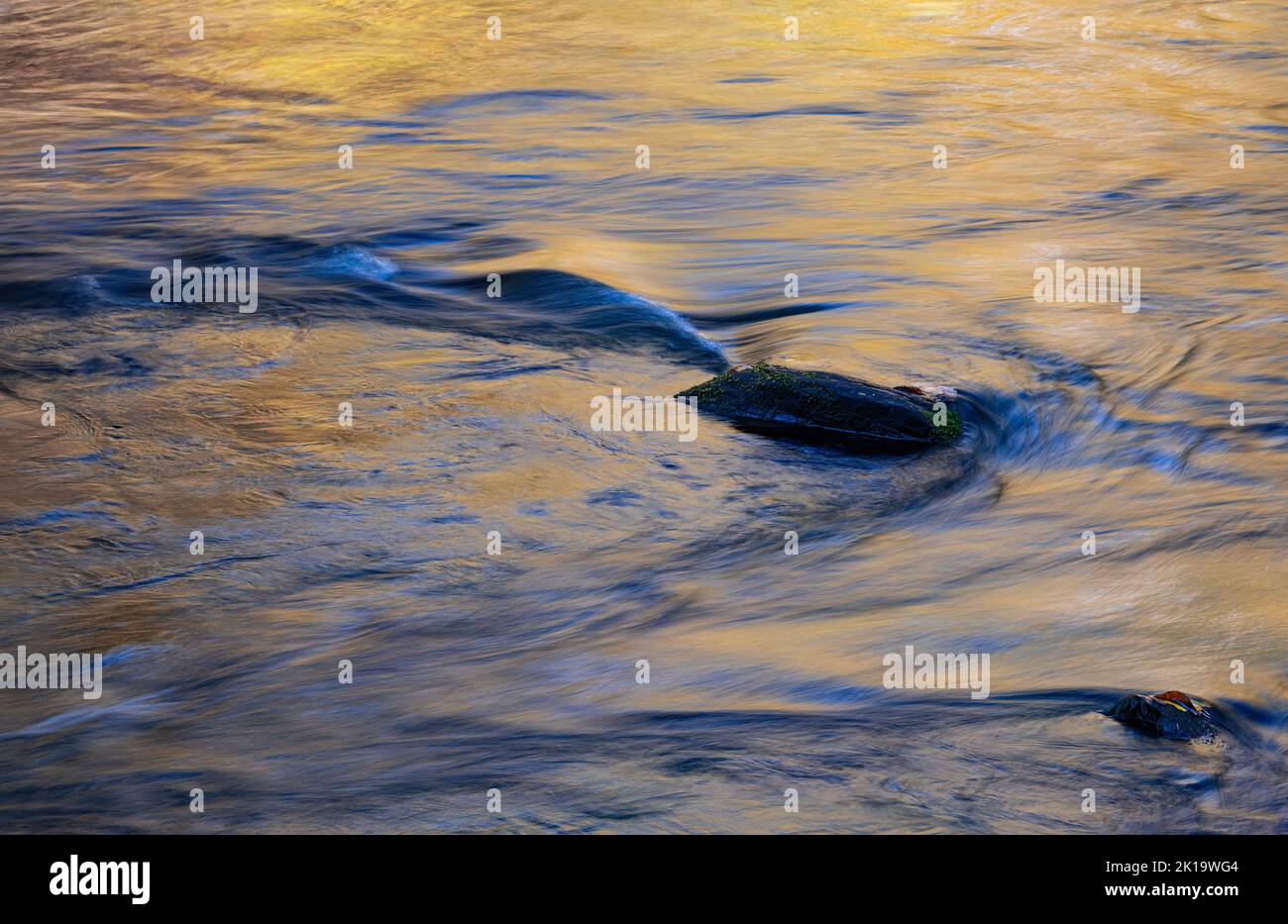 Late afternoon light is reflected in the waters of the Little River in ...