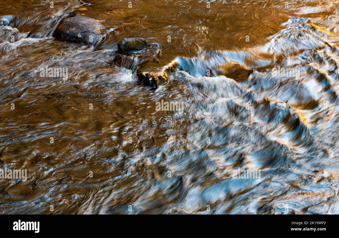 Late gold light reflects in the waters of the Little River along Laurel ...