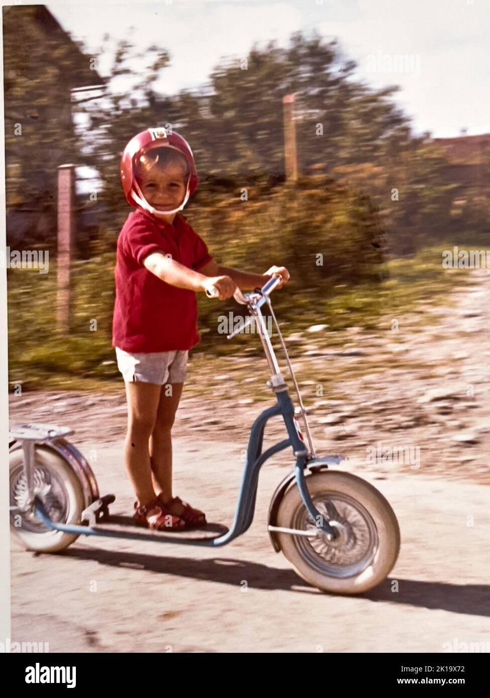 Historical Photo: A boy on a old fashioned scooter with helmet at 1968 ...