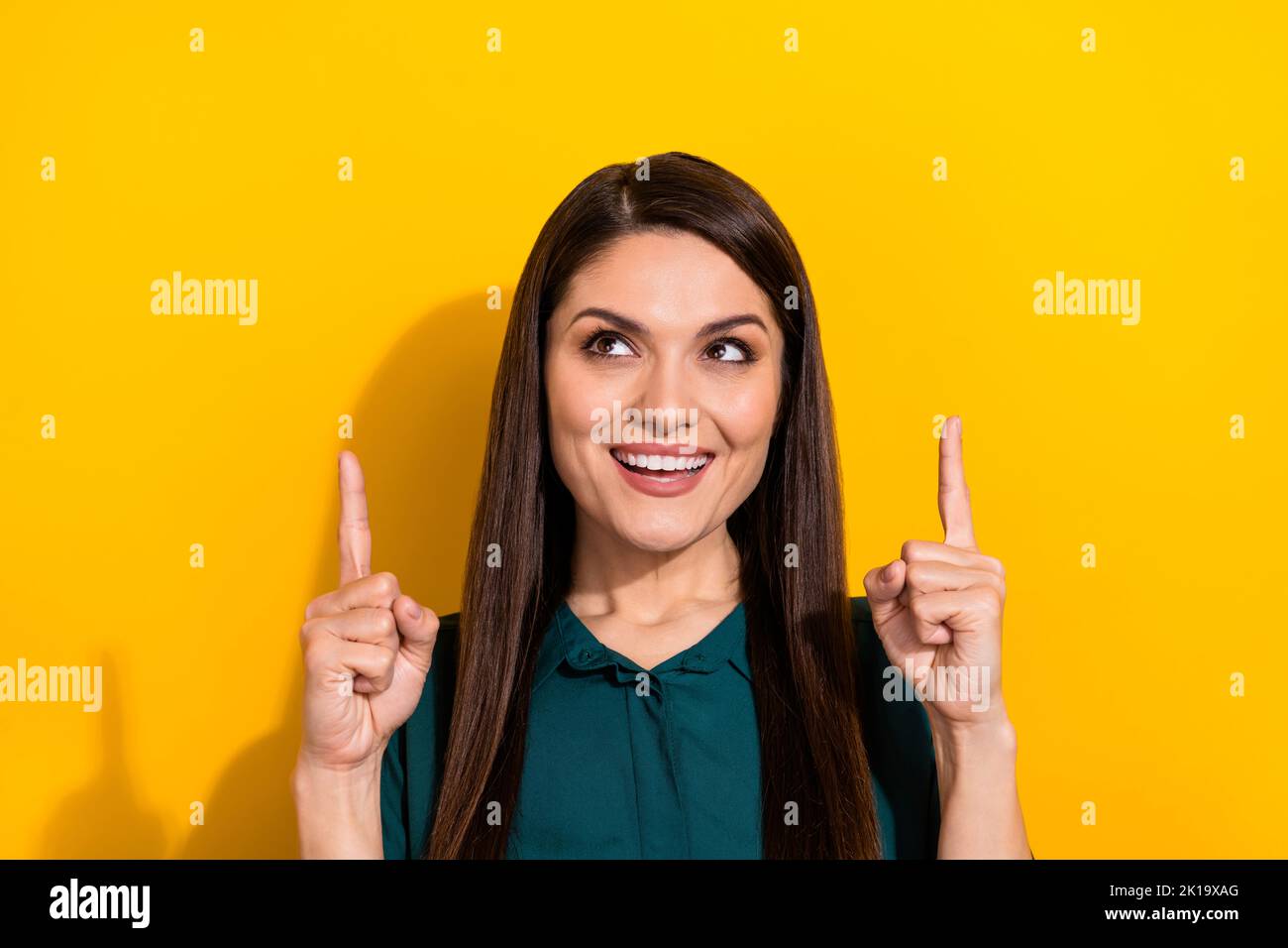 Photo of young excited lady look indicate finger empty space recommend ...