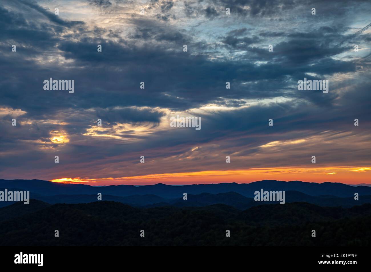A spectacular sunset starts to brighten as the clouds under lit from ...
