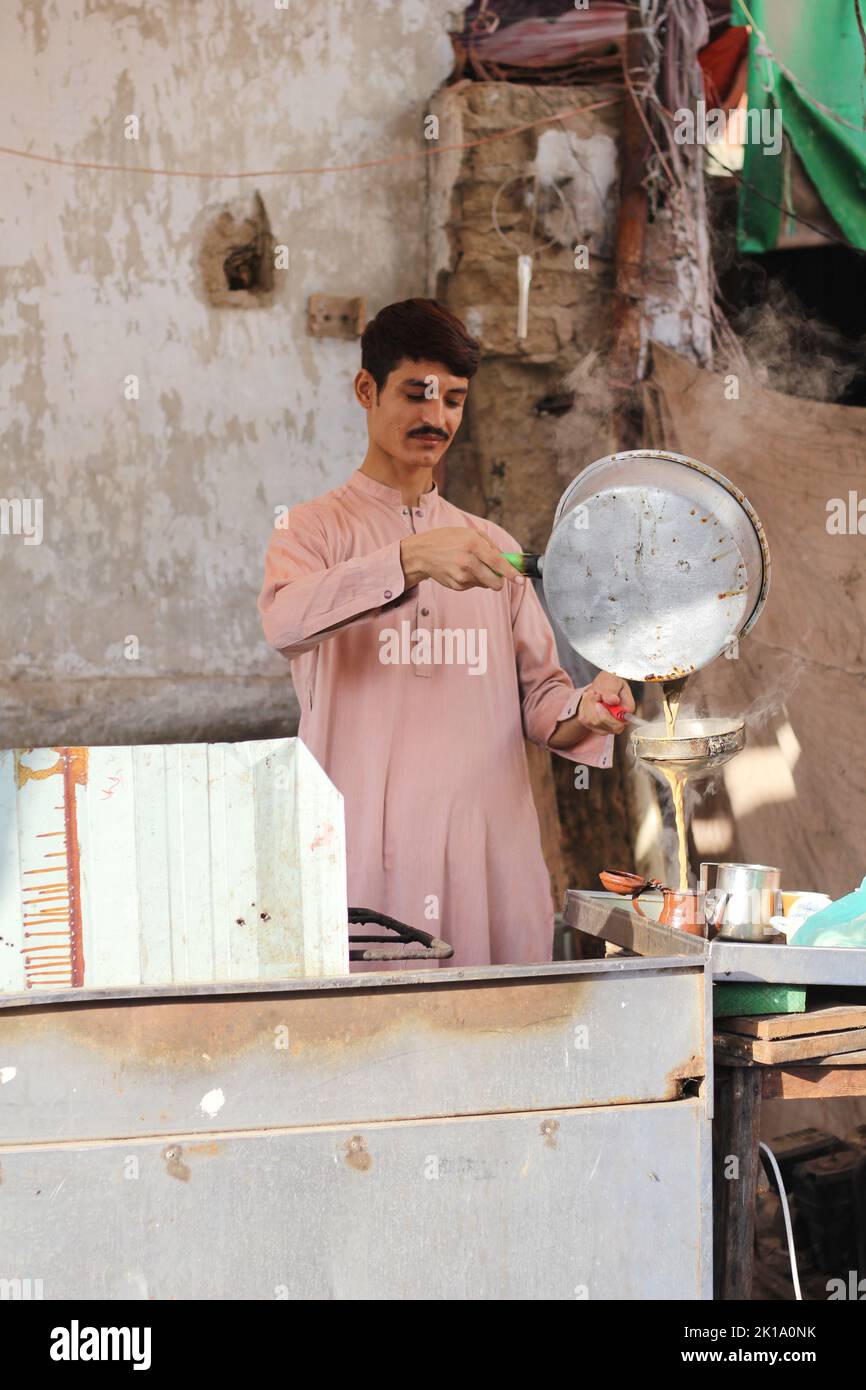 A vertical shallow focus of a Pakistani male with a mustache making ...