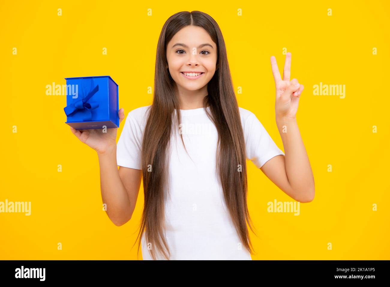 Happy teenager portrait. Child with gift present box on isolated ...