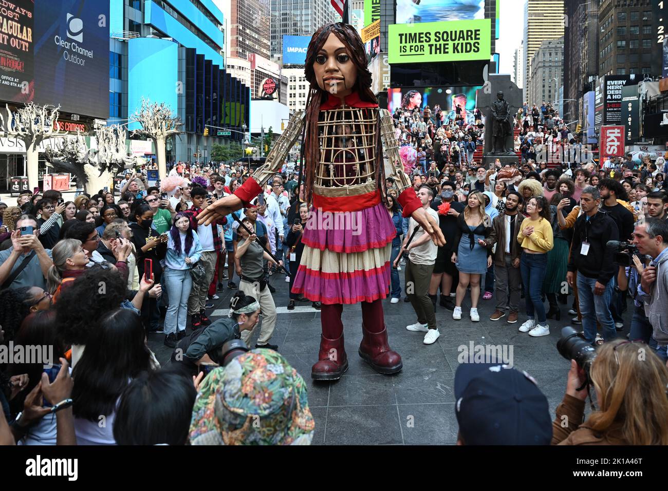 The 12-foot puppet known as "Little Amal" walks through Times Square as ...