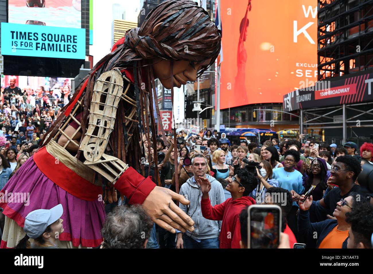 The 12-foot puppet known as "Little Amal" walks through Times Square as ...