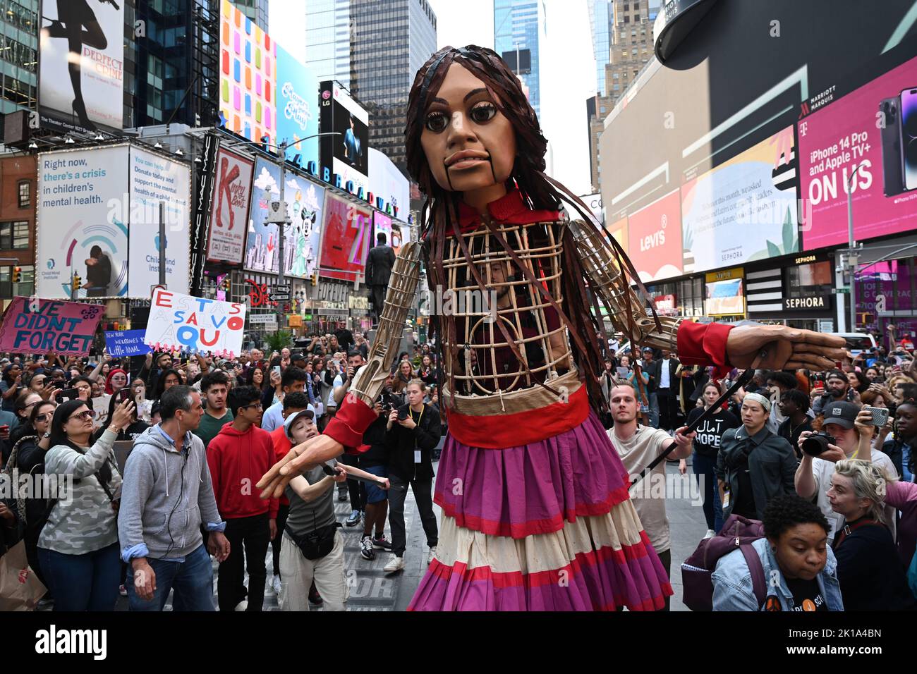 The 12-foot puppet known as "Little Amal" walks through Times Square as ...
