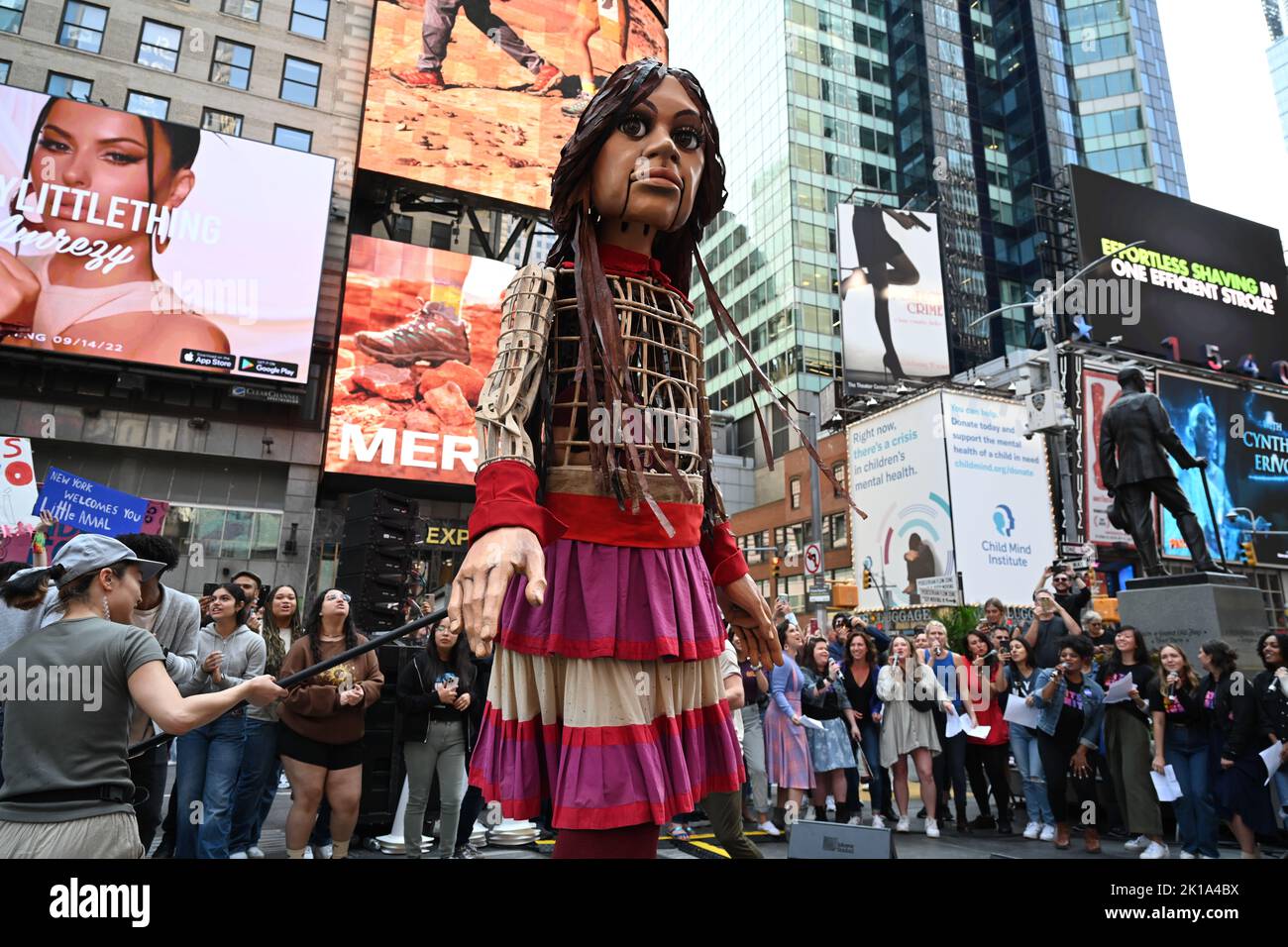 The 12-foot puppet known as "Little Amal" walks through Times Square as ...