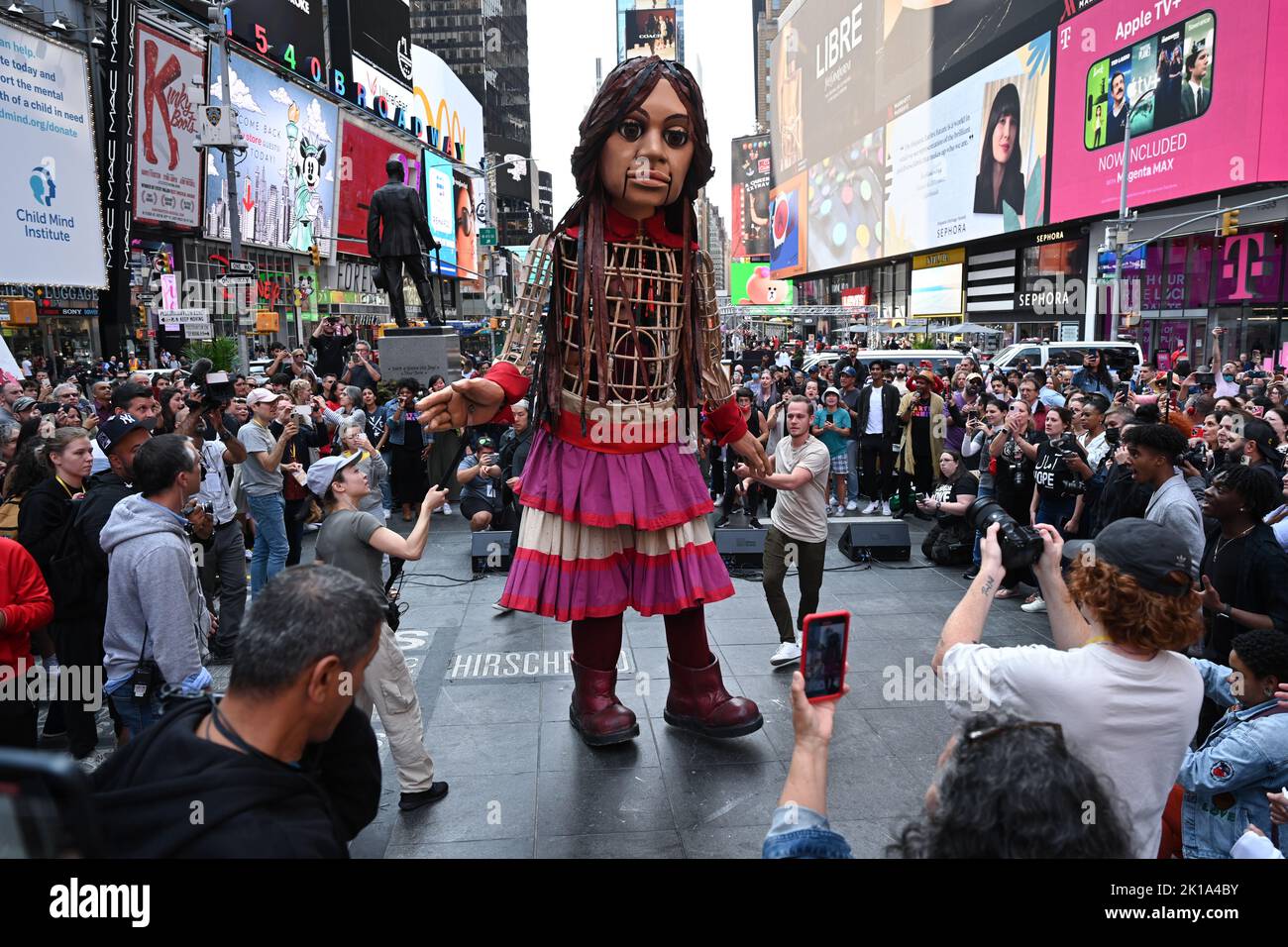 The 12-foot puppet known as "Little Amal" walks through Times Square as ...