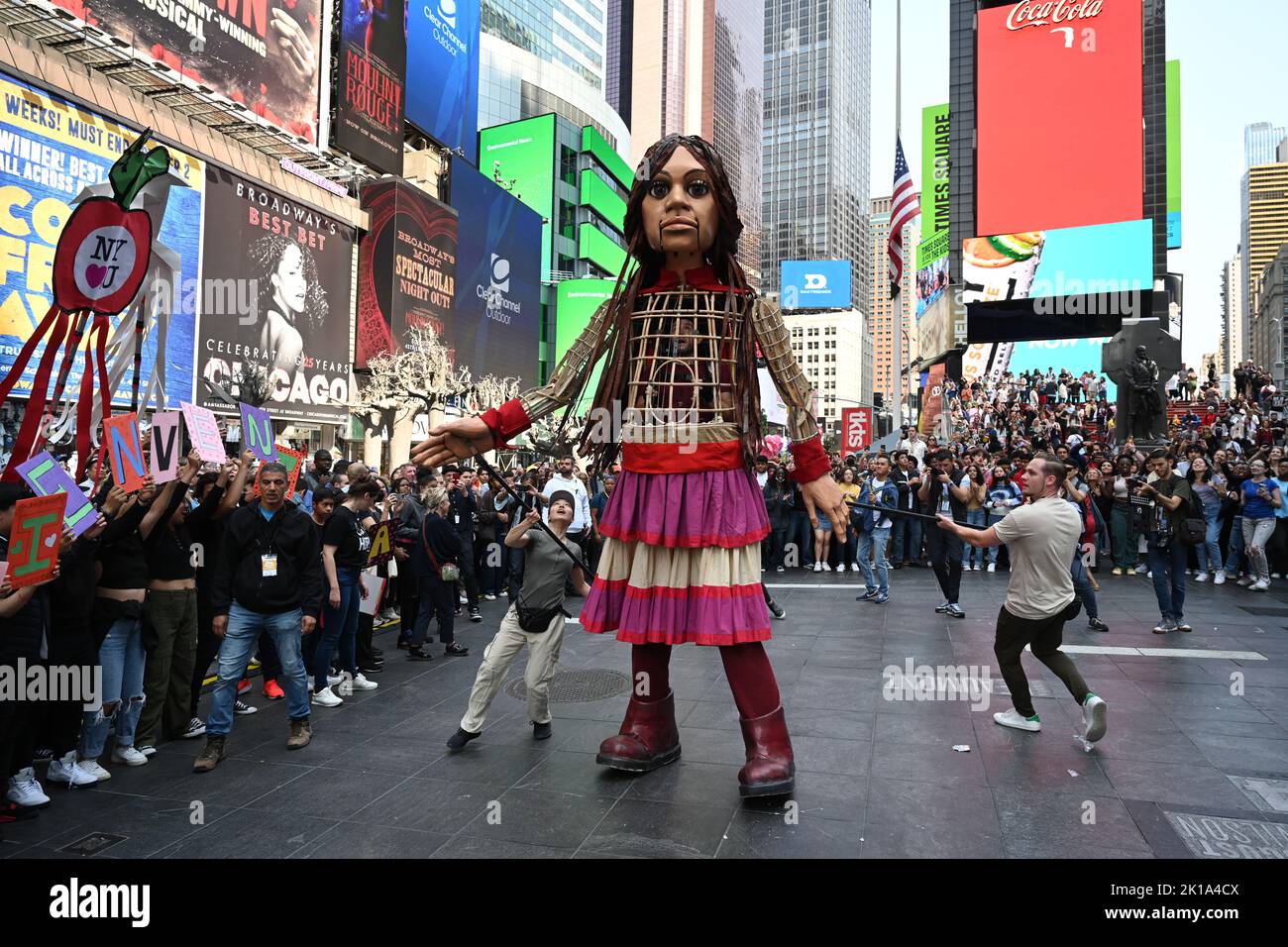 The 12-foot puppet known as "Little Amal" walks through Times Square as ...
