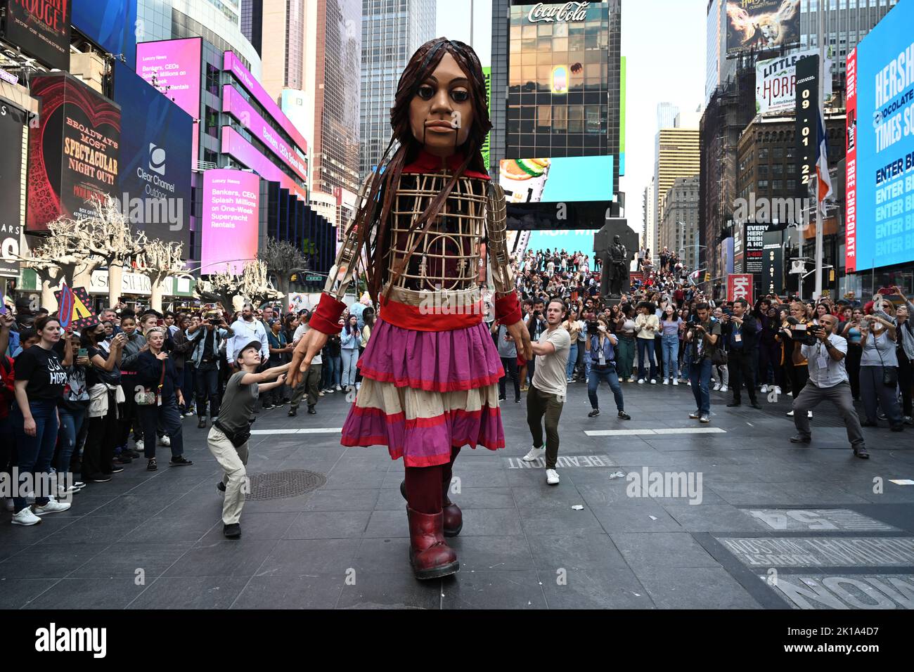The 12-foot puppet known as "Little Amal" walks through Times Square as ...