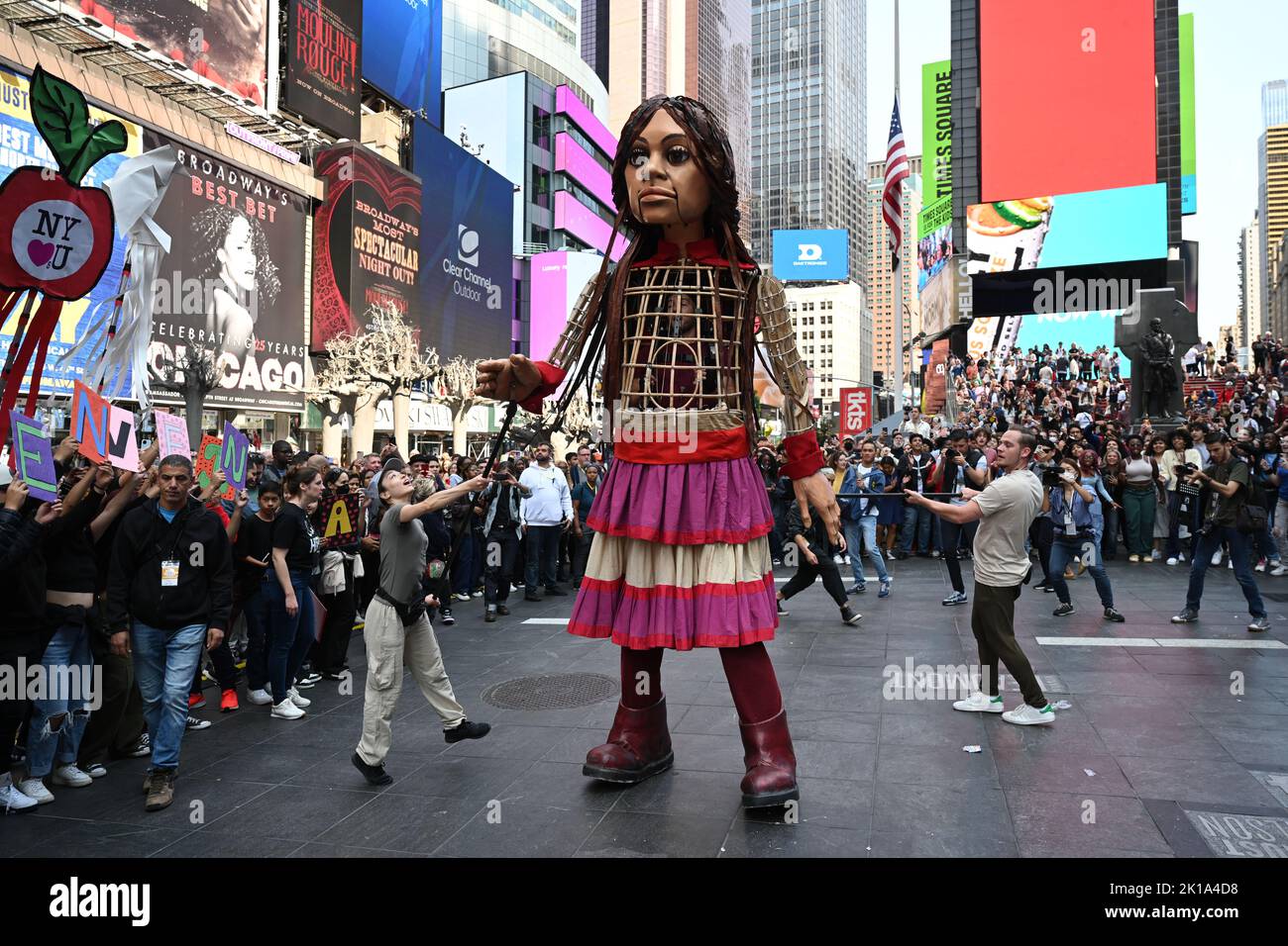 The 12-foot puppet known as "Little Amal" walks through Times Square as ...