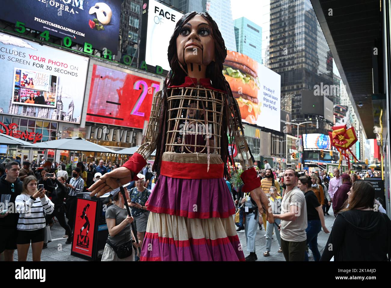 The 12-foot puppet known as "Little Amal" walks through Times Square as ...