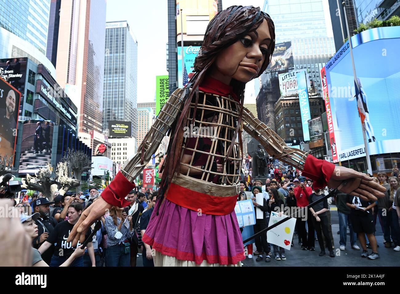 The 12-foot puppet known as "Little Amal" walks through Times Square as ...