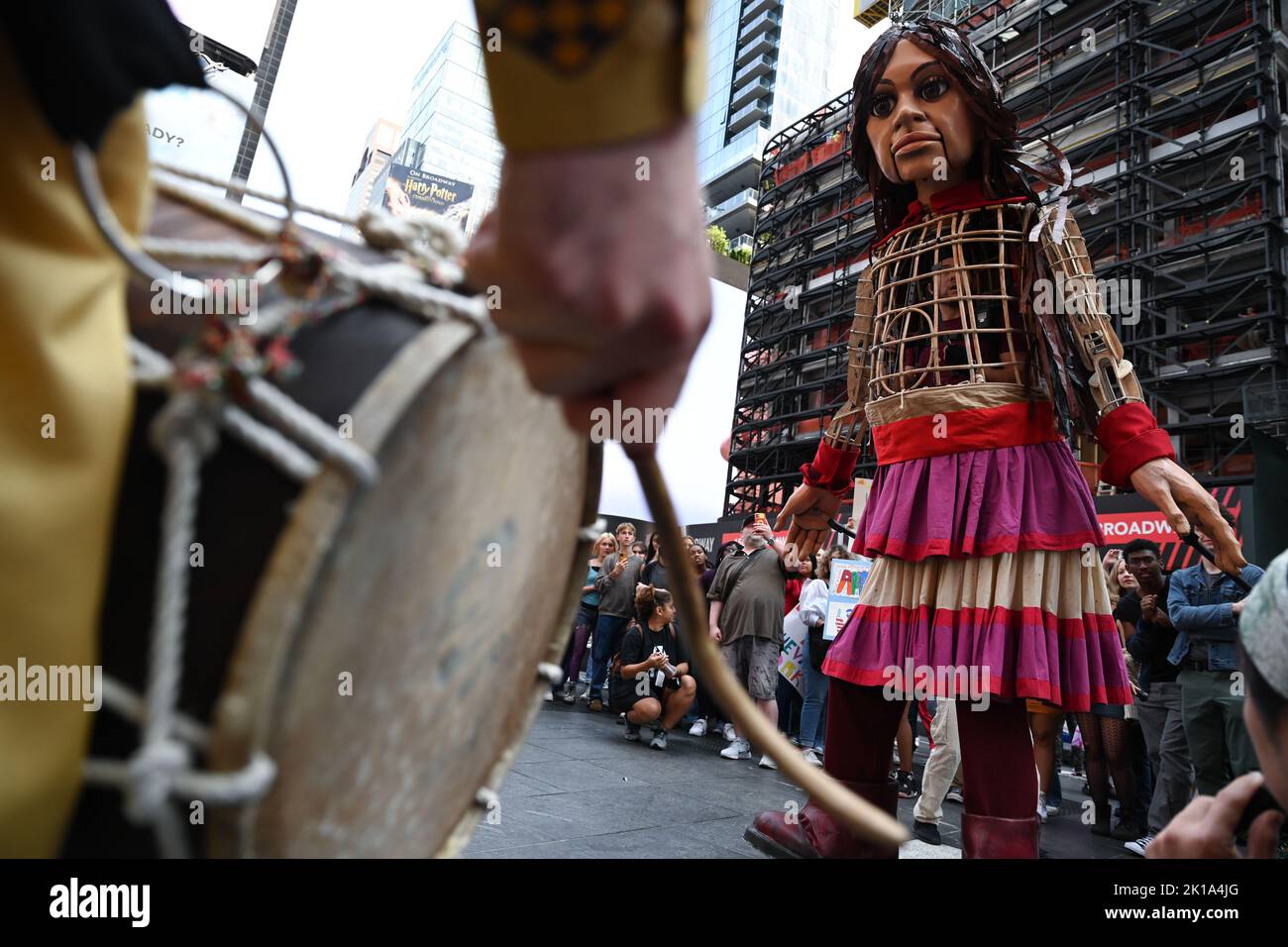 The 12-foot puppet known as "Little Amal" walks through Times Square as ...