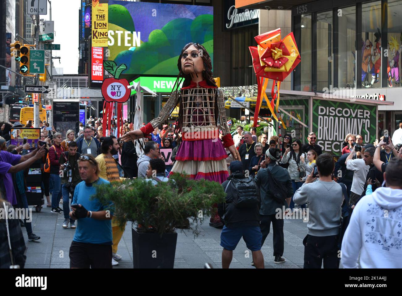 The 12-foot puppet known as "Little Amal" walks through Times Square as ...