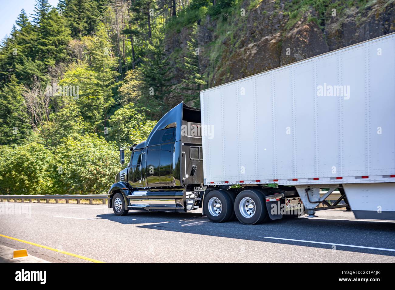 Industrial big rig black fresh semi truck tractor transporting ...