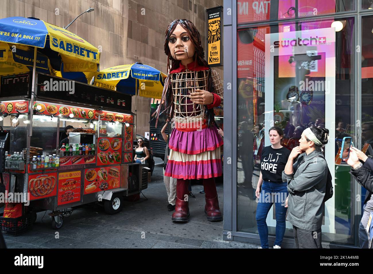 The 12-foot puppet known as "Little Amal" walks through Times Square as ...