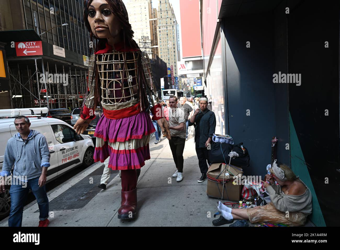 The 12-foot puppet known as "Little Amal" walks through Times Square as ...