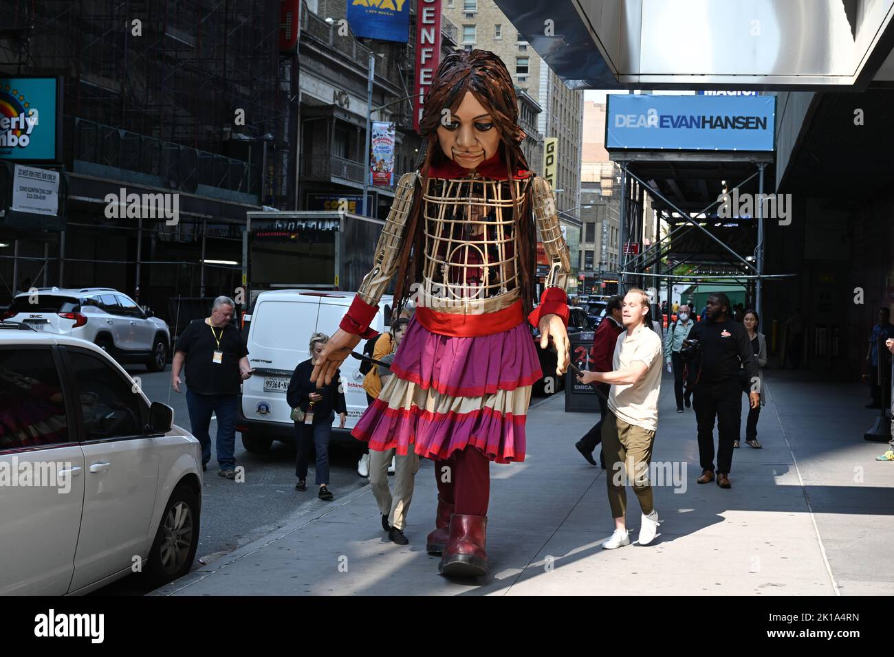 The 12-foot puppet known as "Little Amal" walks through Times Square as ...