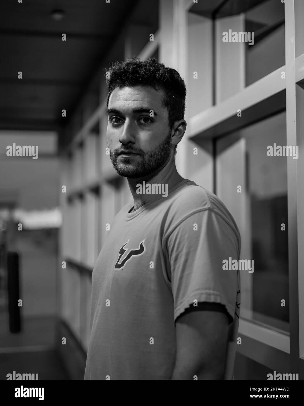 A vertical portrait of a young man in grayscale Stock Photo - Alamy
