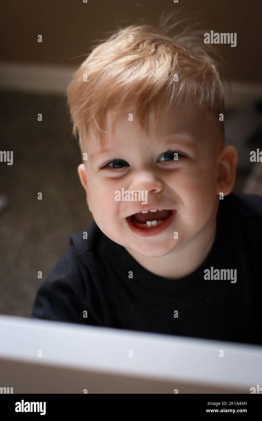 close portrait of a baby boy laughing Stock Photo - Alamy