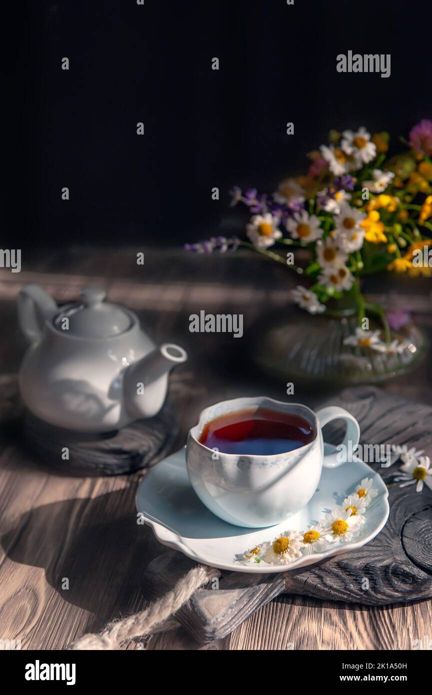 herbal tea in a blue porcelain cup. Morning still life with beautiful ...