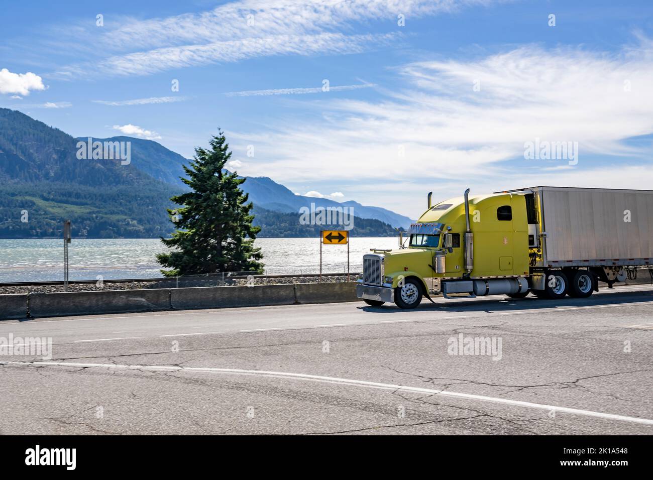 American bright yellow powerful old classic big rig semi truck tractor ...