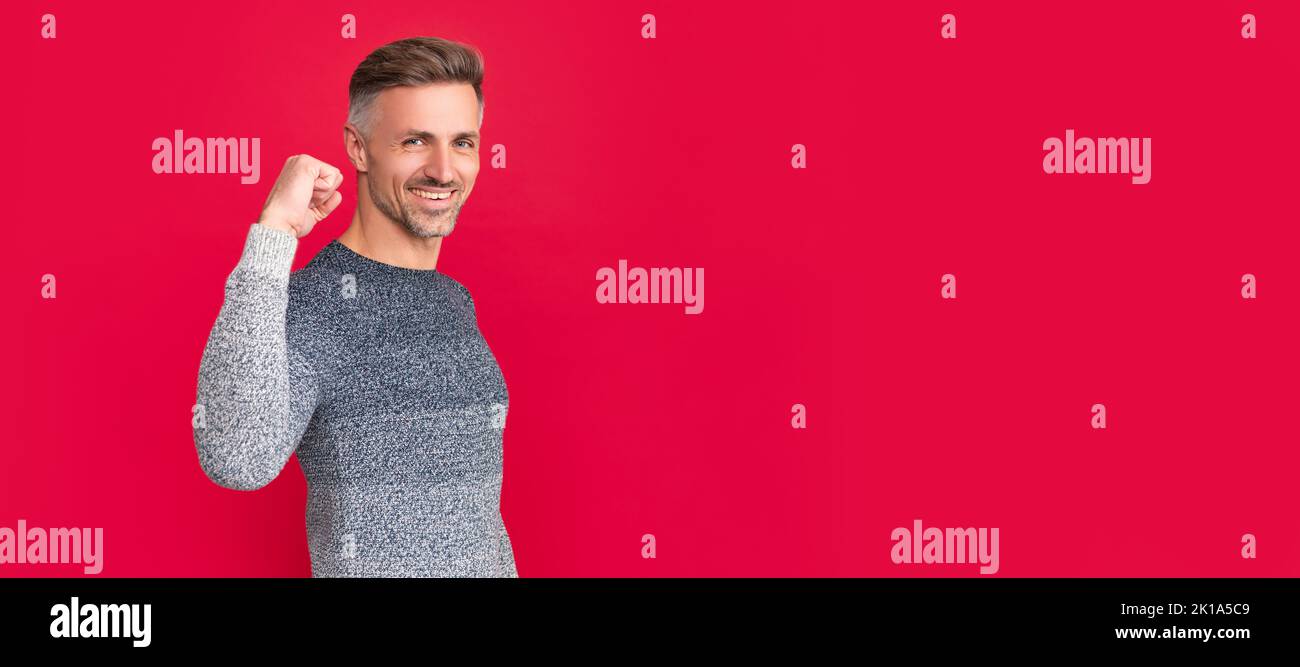 happy successful man in sweater on red background, success. Man face ...