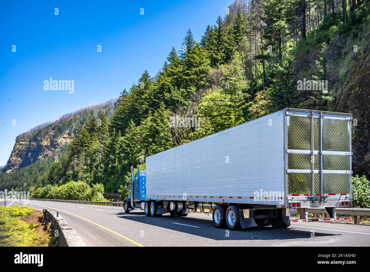 Classic blue long haul big rig semi truck tractor with chrome exhaust ...