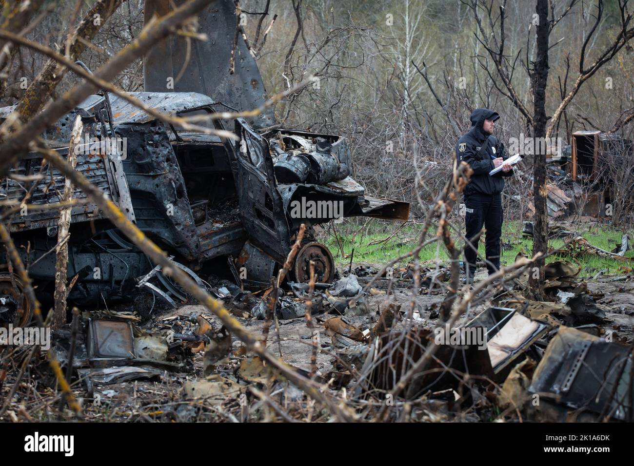 A police officer documents the war crimes of the Russian army in ...